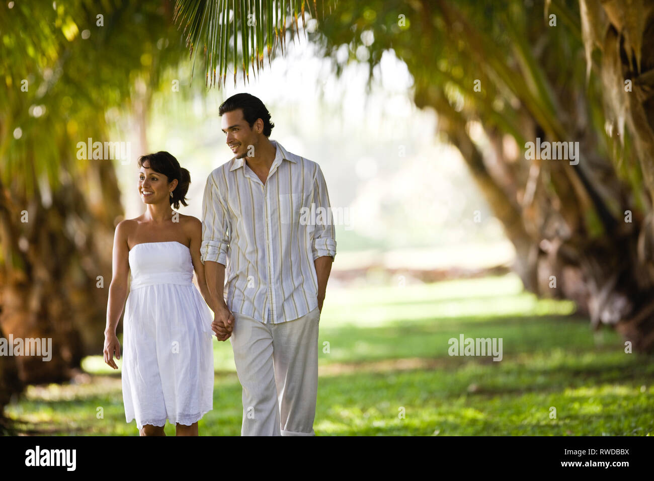 Couple walking hand in hand Stock Photo - Alamy