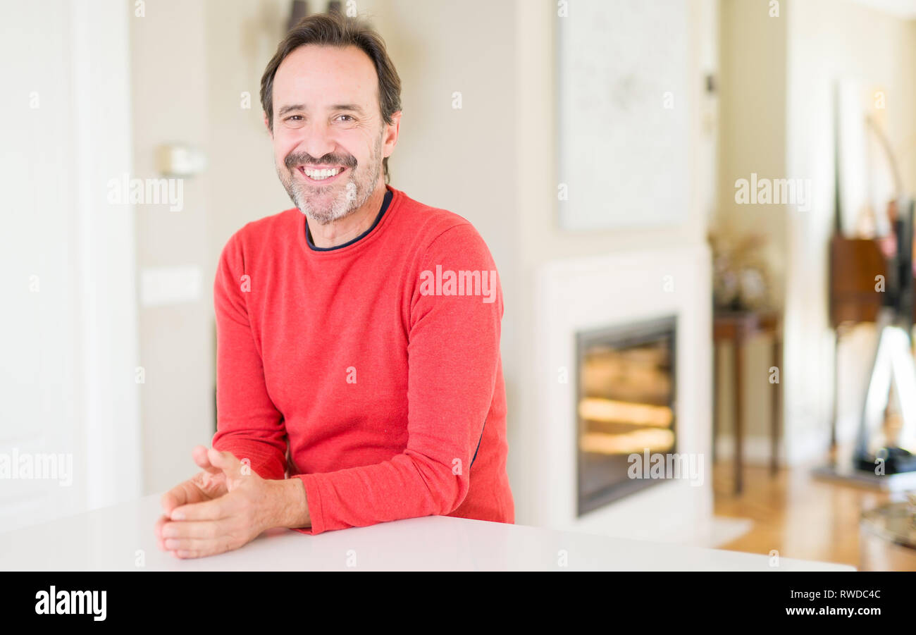 Handsome middle age man smiling looking at the camera at home Stock ...