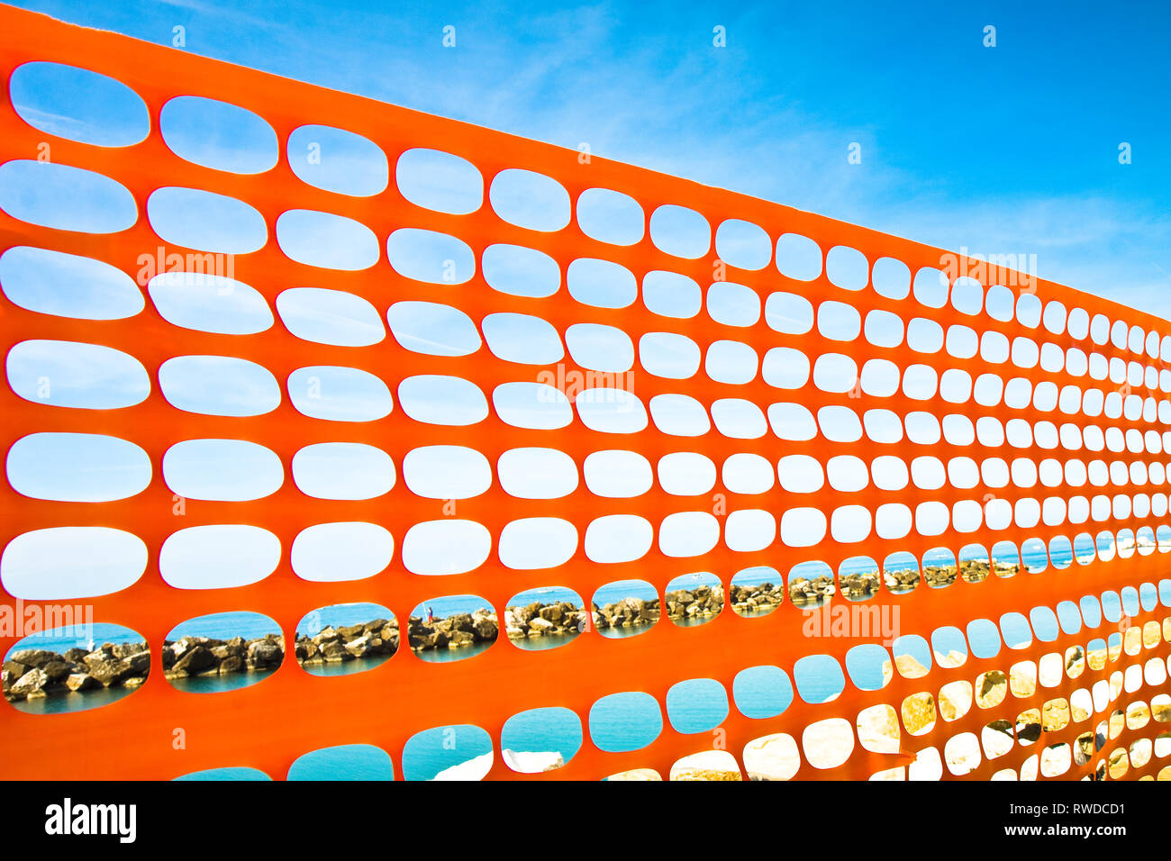 Orange plastic grid around a construction site on the coastline Stock ...