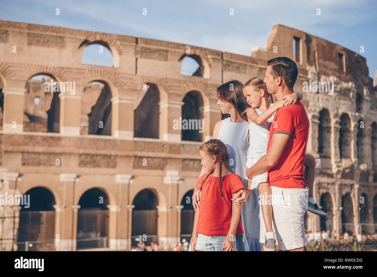 Happy family in Rome over Coliseum background Stock Photo - Alamy