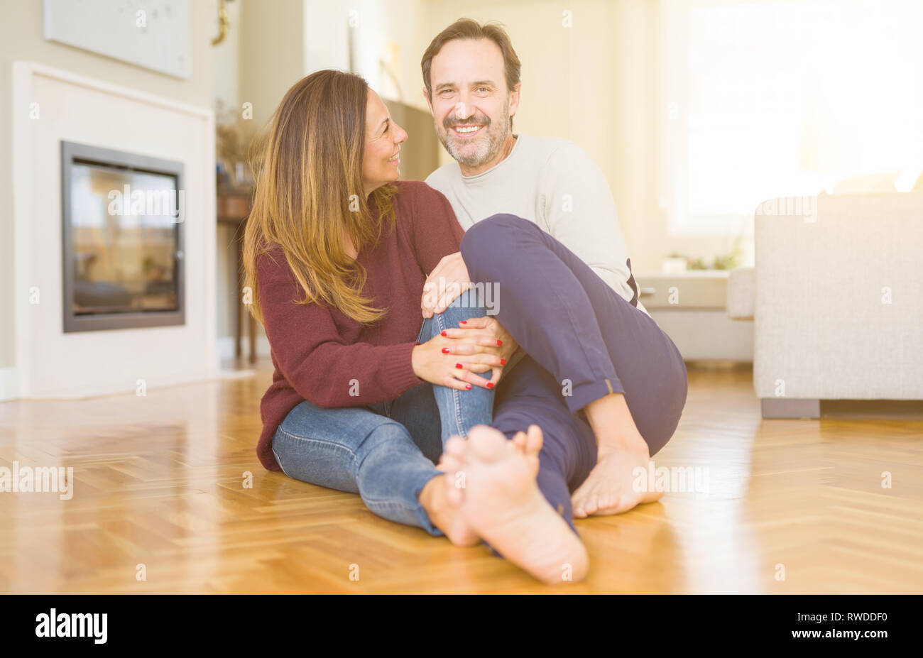 Beautiful romantic couple sitting together on the floor at home Stock ...