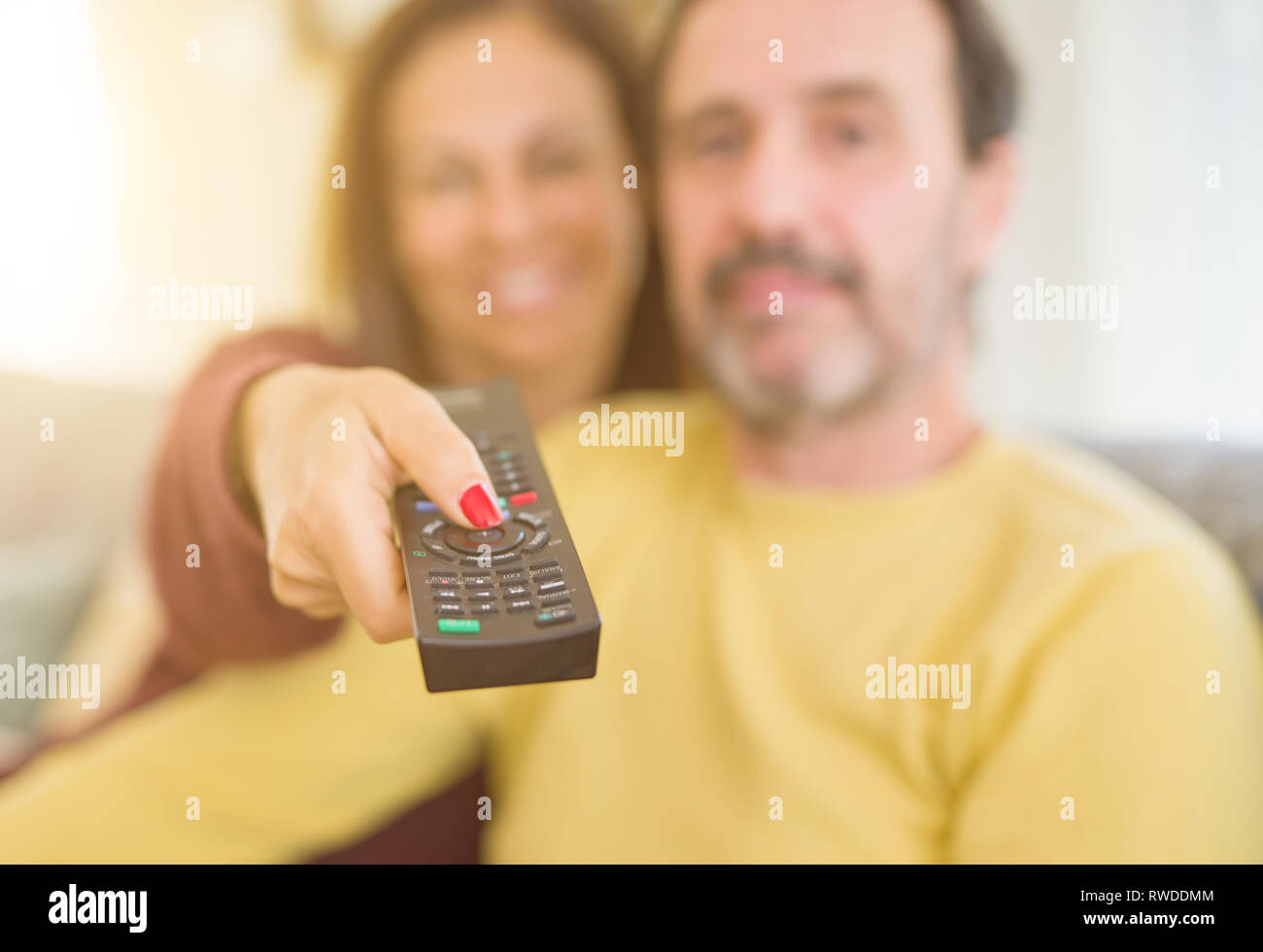 Romantic middle age couple watching tv on the sofa at home Stock Photo ...