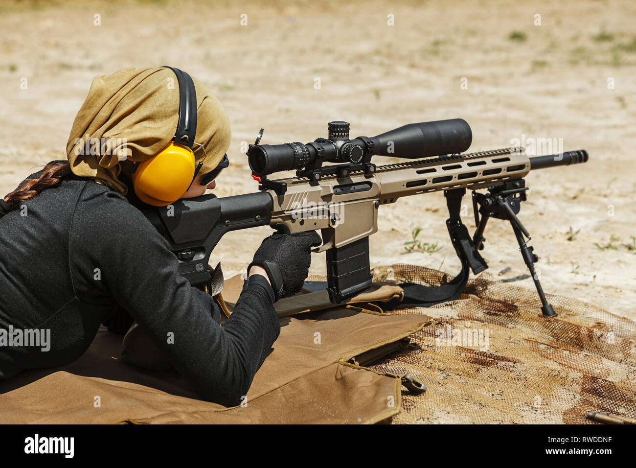 Young female sniper in camouflage with gun in the desert Stock Photo ...