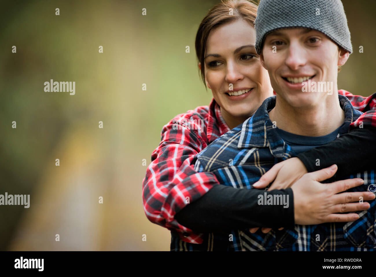Young couple with arms around each other Stock Photo - Alamy