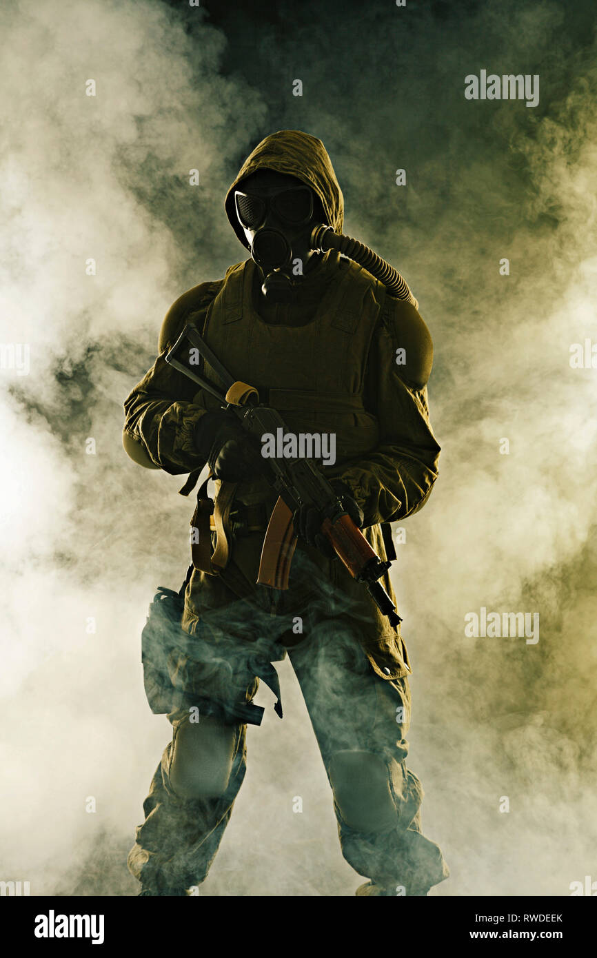 Post apocalypse survivor with weapons and gas mask, studio shot Stock ...