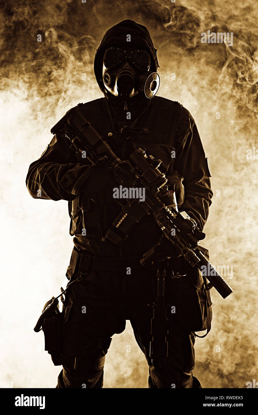 Post apocalypse survivor with weapons and gas mask, studio shot Stock ...