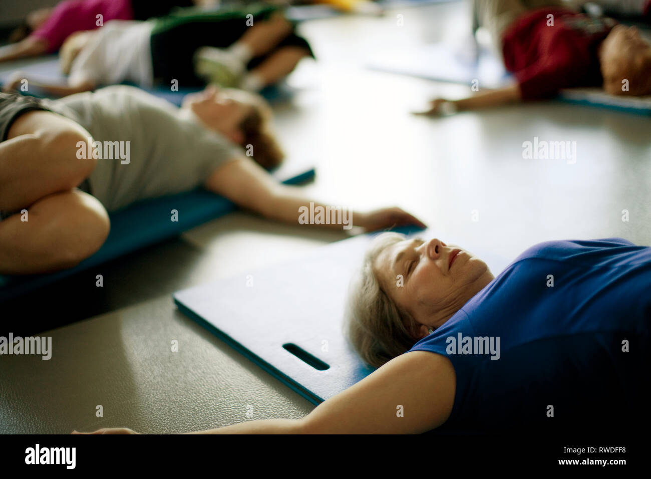 Elderly exercise class stretches on mat Stock Photo - Alamy