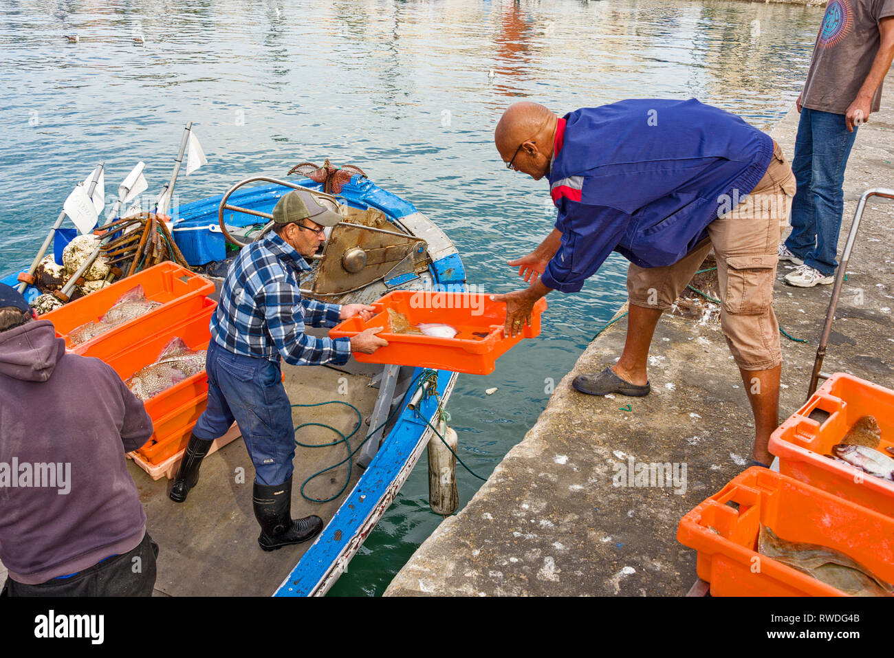 Unloading fish hi-res stock photography and images - Alamy