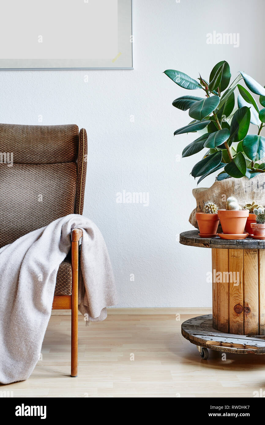 armchair and side table lounge atmosphere hygge design Stock Photo - Alamy