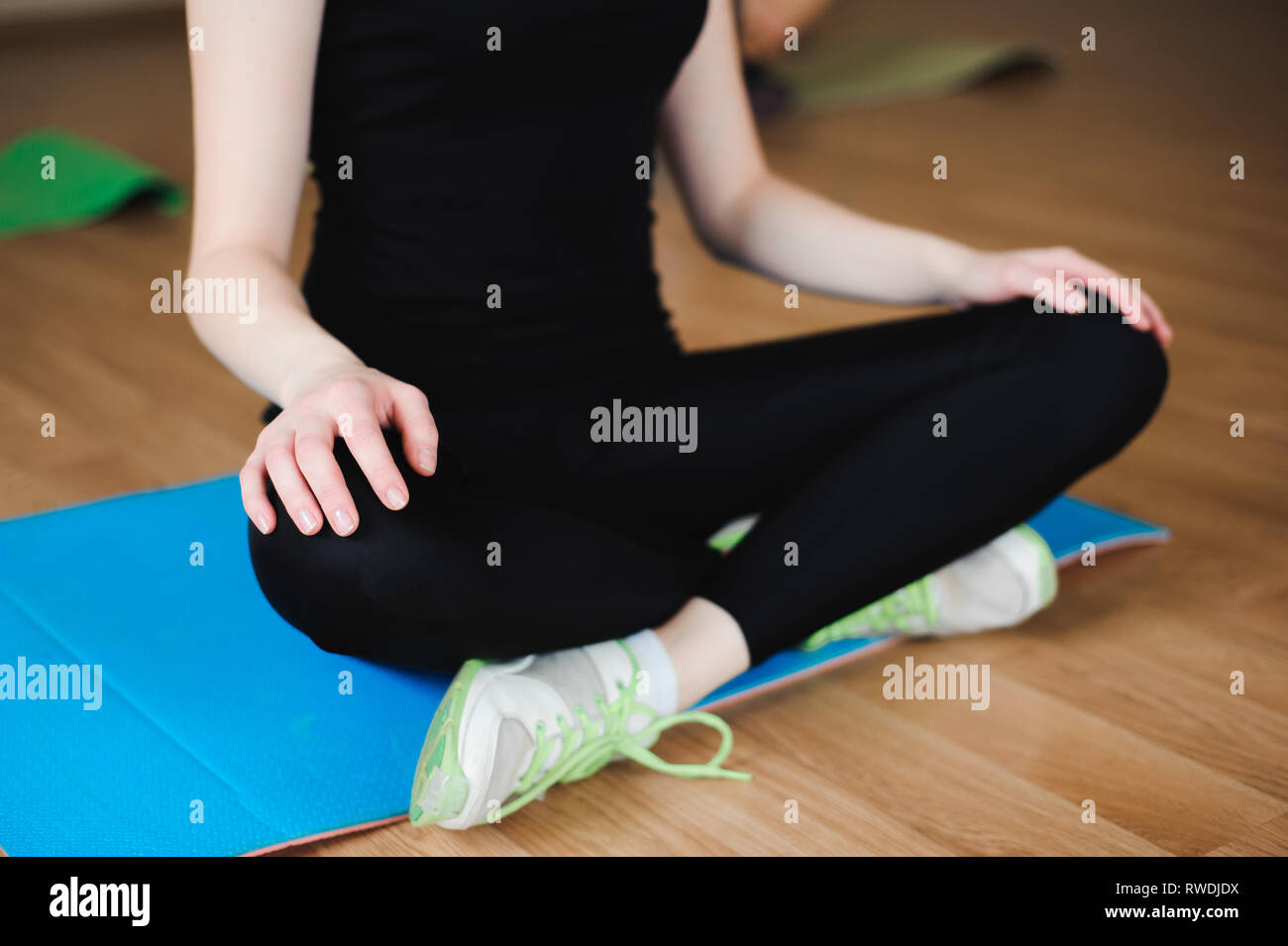 athletic woman doing relaxation exercises in gym class Stock Photo - Alamy