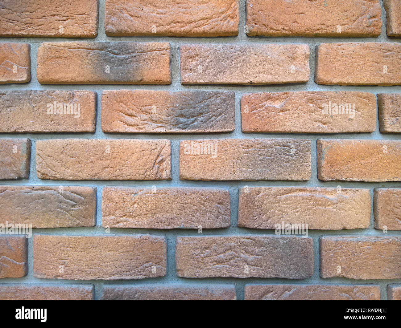 Orange exterior decorative brick wall Stock Photo - Alamy