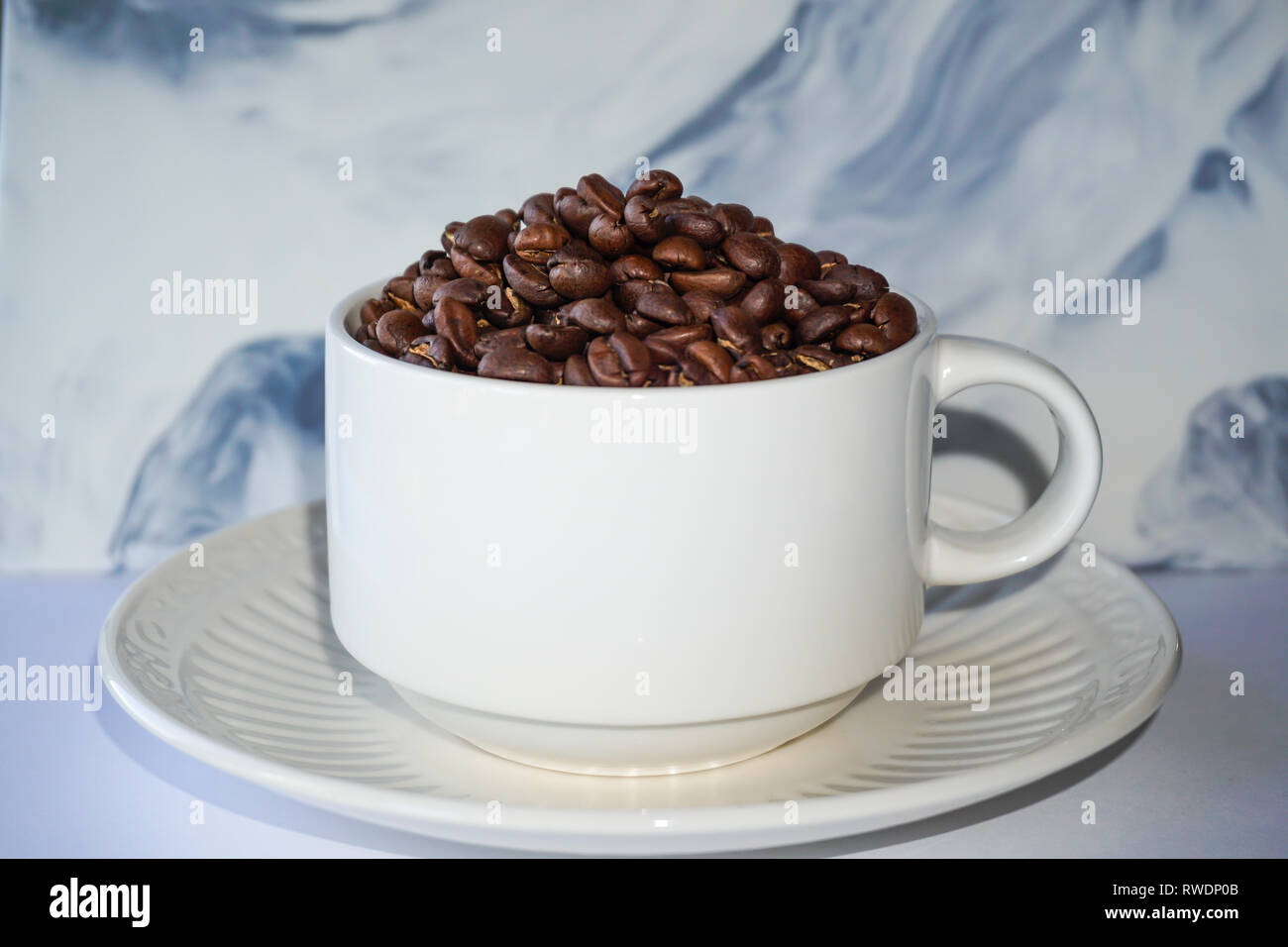 White coffee cup filled by coffee beans Stock Photo - Alamy