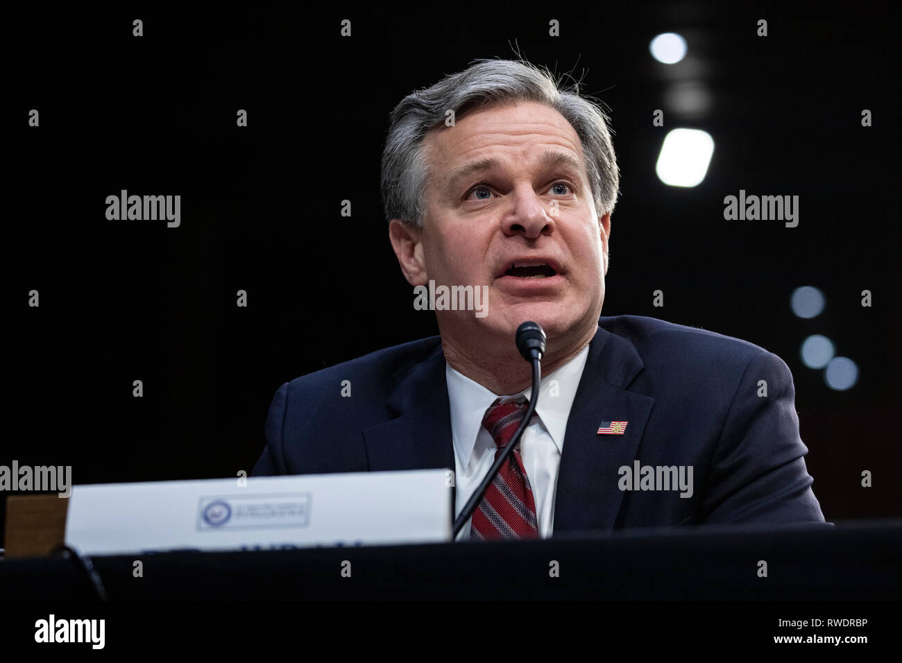 FBI Director Christopher Wray testifies during a Senate Intelligence ...