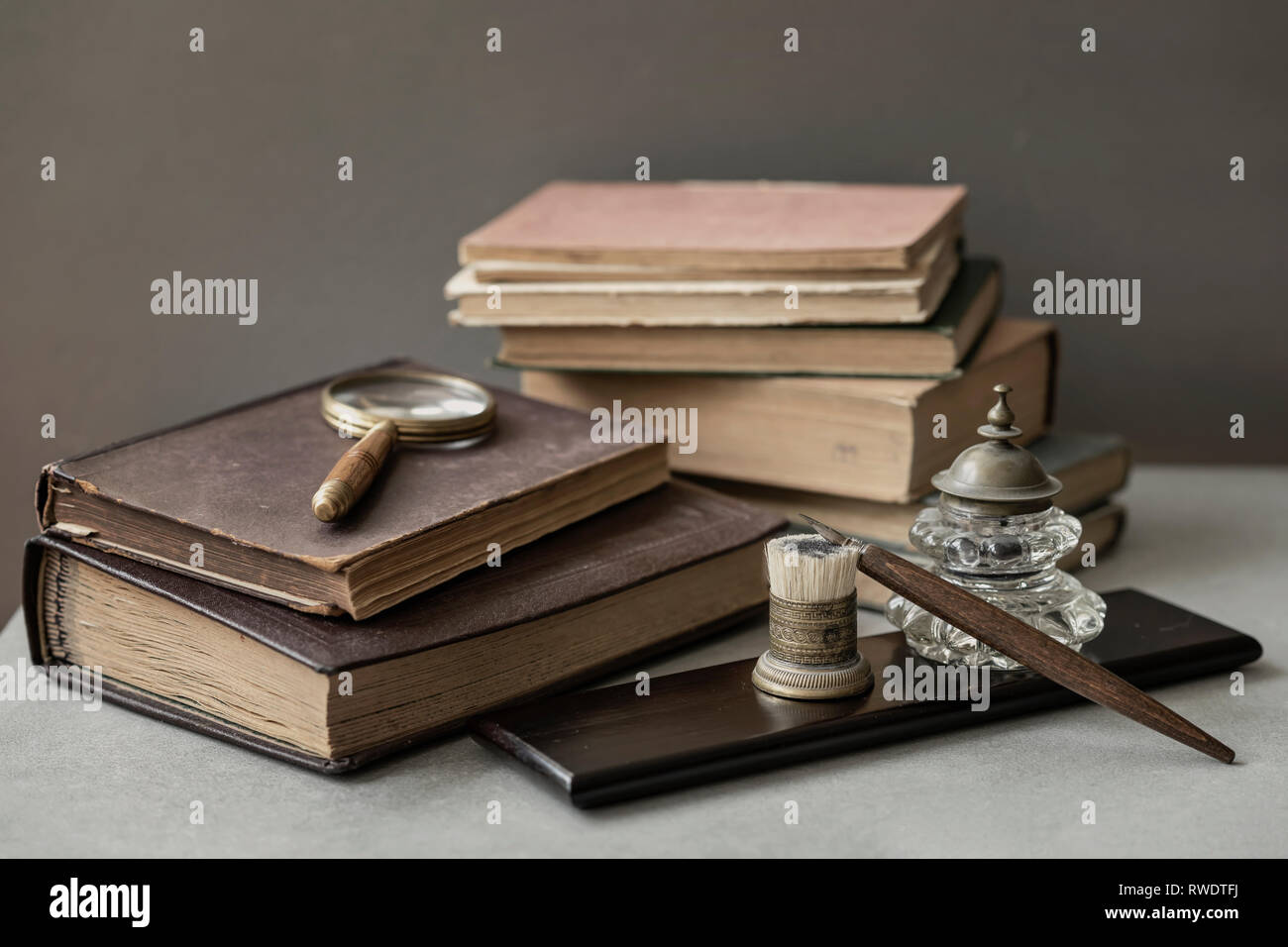 Several of antic books, set of old stationery, wooden pen, inkwell ...