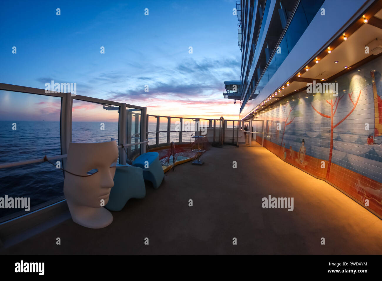 Open deck of a luxury cruise ship in the middle of the sunset, with ...