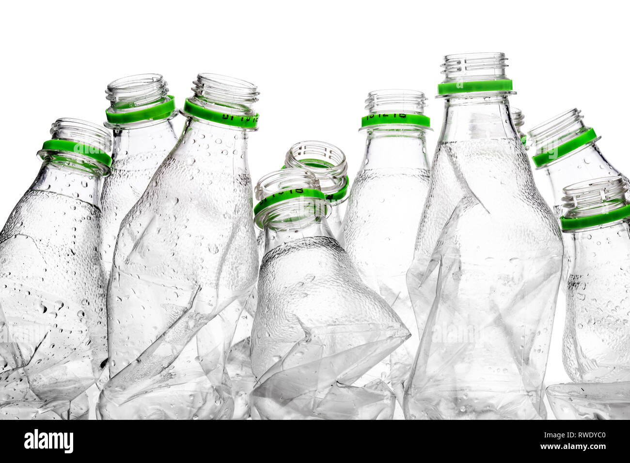 group of smashed empty plastic bottles with green caps, isolated on ...
