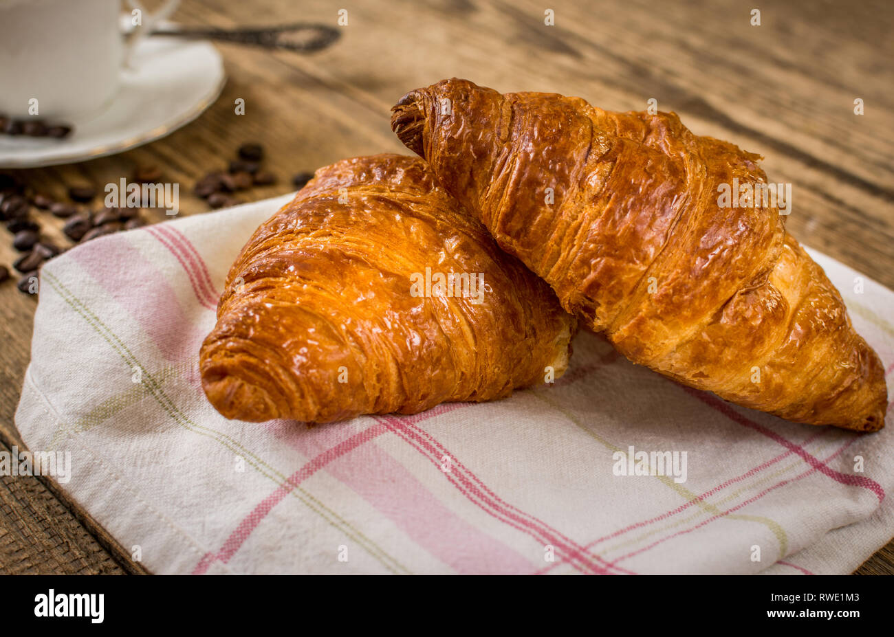 Traditional french breakfast croissant and coffee on wood table Stock ...