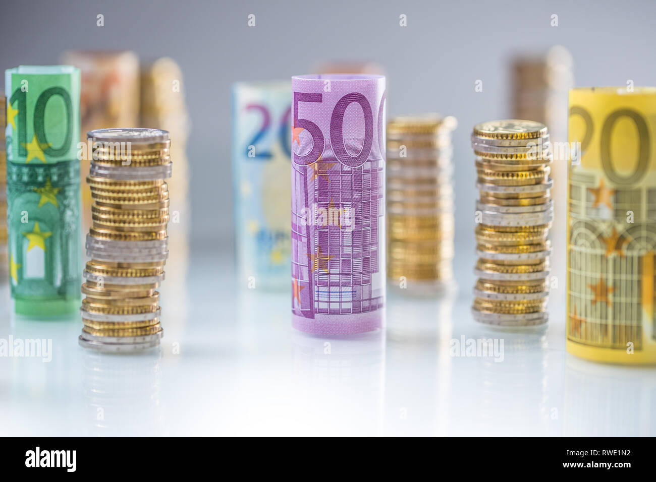 Rolled euro banknotes and coins towers stacked in other positions Stock ...