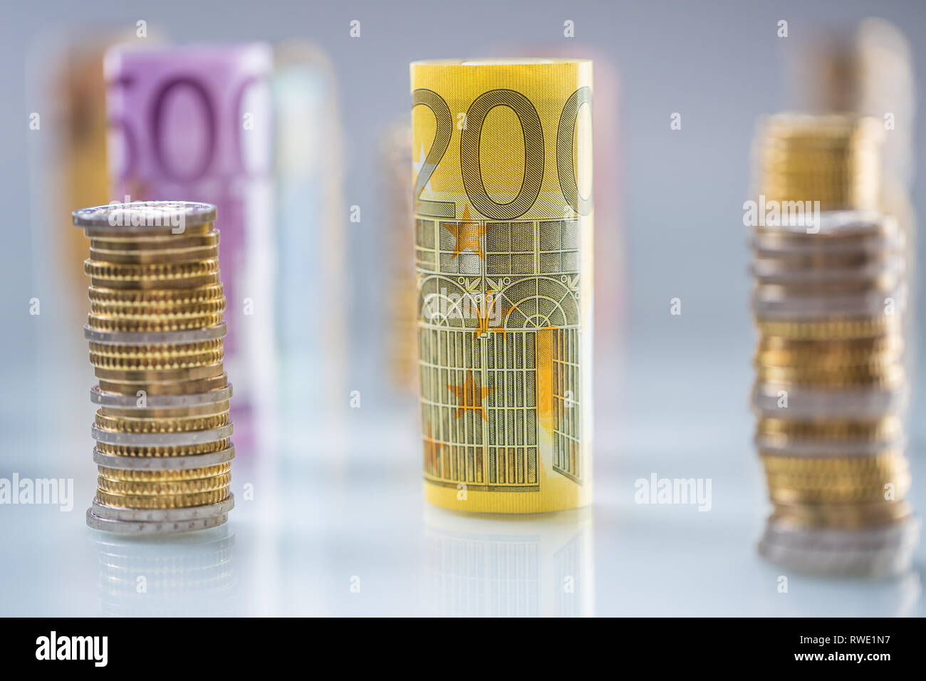 Rolled euro banknotes and coins towers stacked in other positions Stock ...