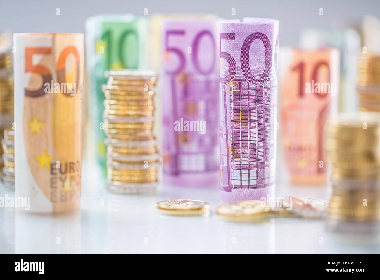 Rolled euro banknotes and coins towers stacked in other positions Stock ...
