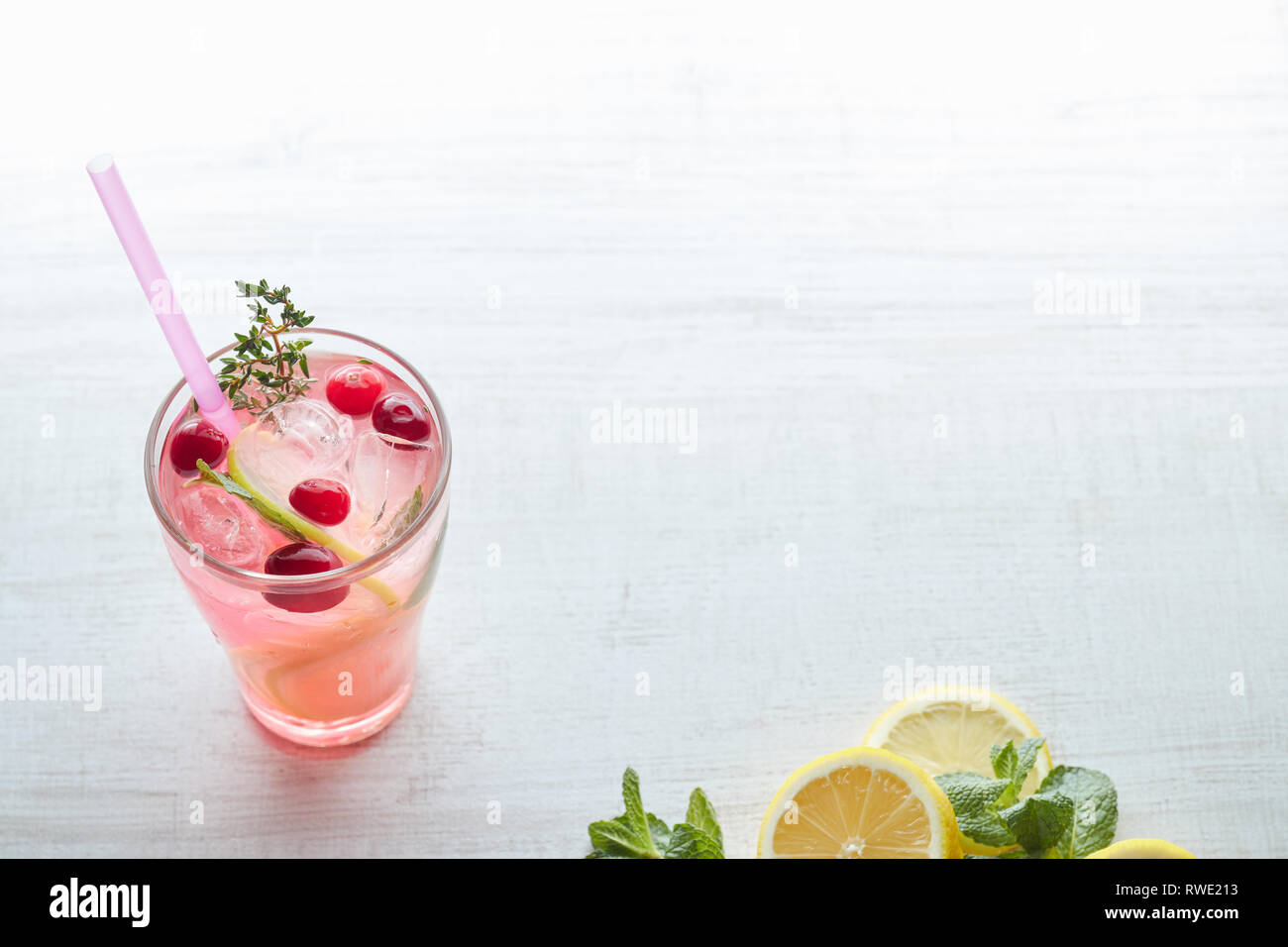 Lemonade with ice and fresh lemon with mint on wooden background ...
