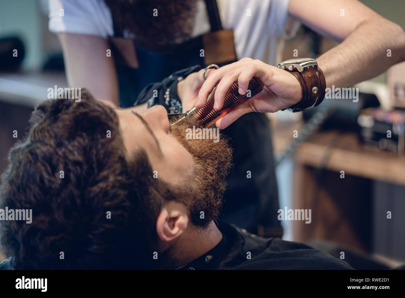 Hand of a barber using scissors while trimming Stock Photo - Alamy