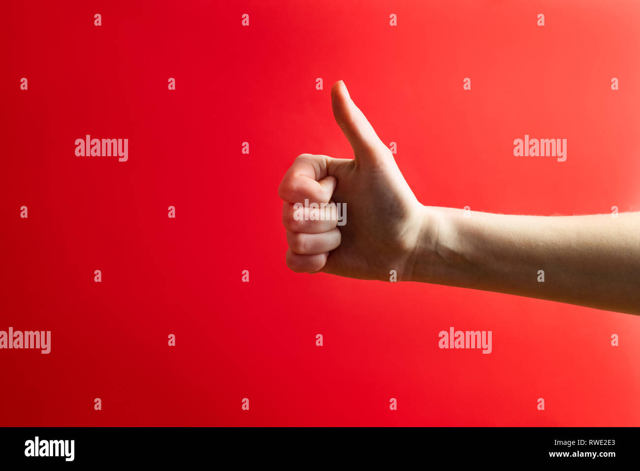 Thumbs up, approval gesture concept. Hand showing a "thumb up" sign in ...