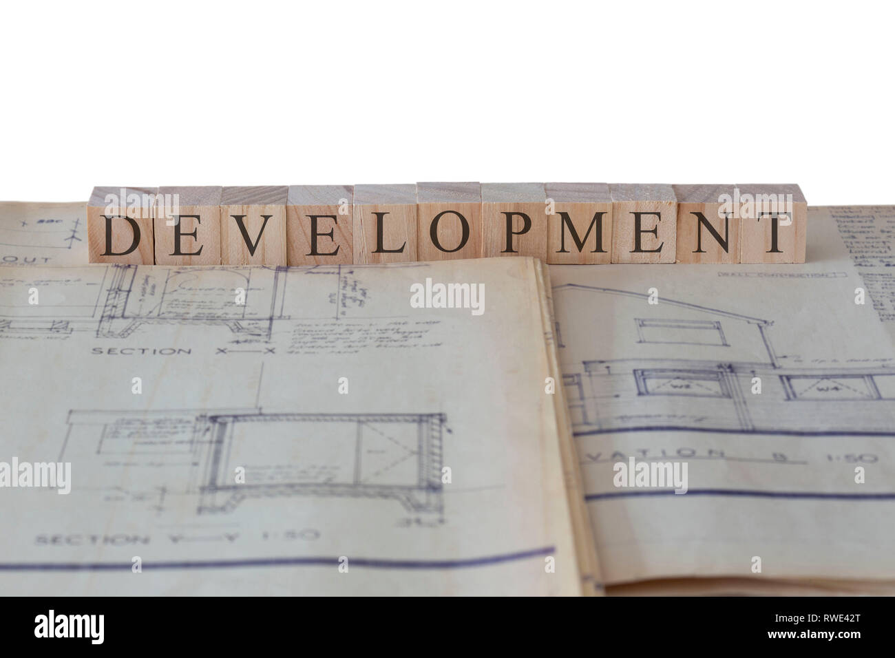 Development written on wooden blocks on house extension building plans ...
