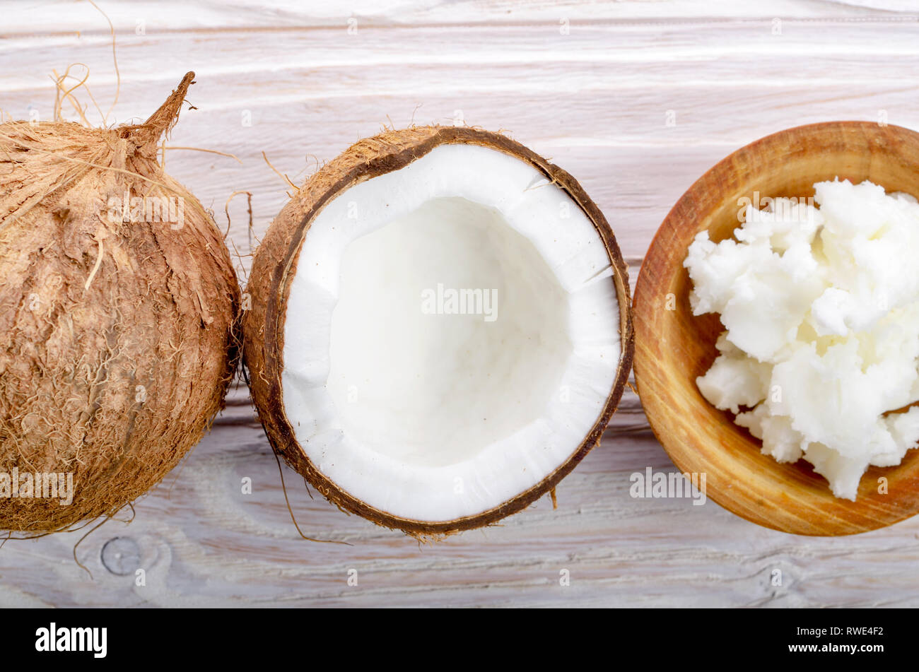 Flat lay background of coconut, coconut shell, hard oil in wooden bowl ...