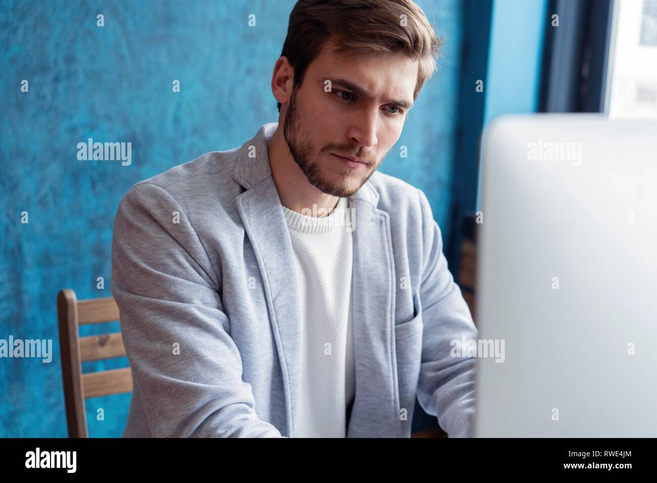 Man Working At Computer In Contemporary Office Stock Photo - Alamy
