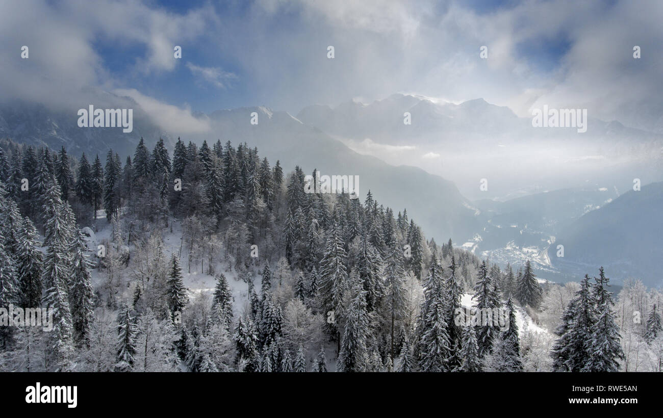 Snow covered winter trees in the foreground frame a perfect winter ...