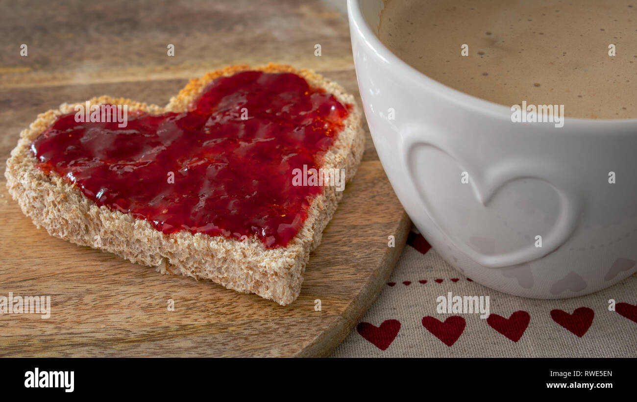 Romantic Breakfast, heart shaped toast with strawberry jam and coffee ...