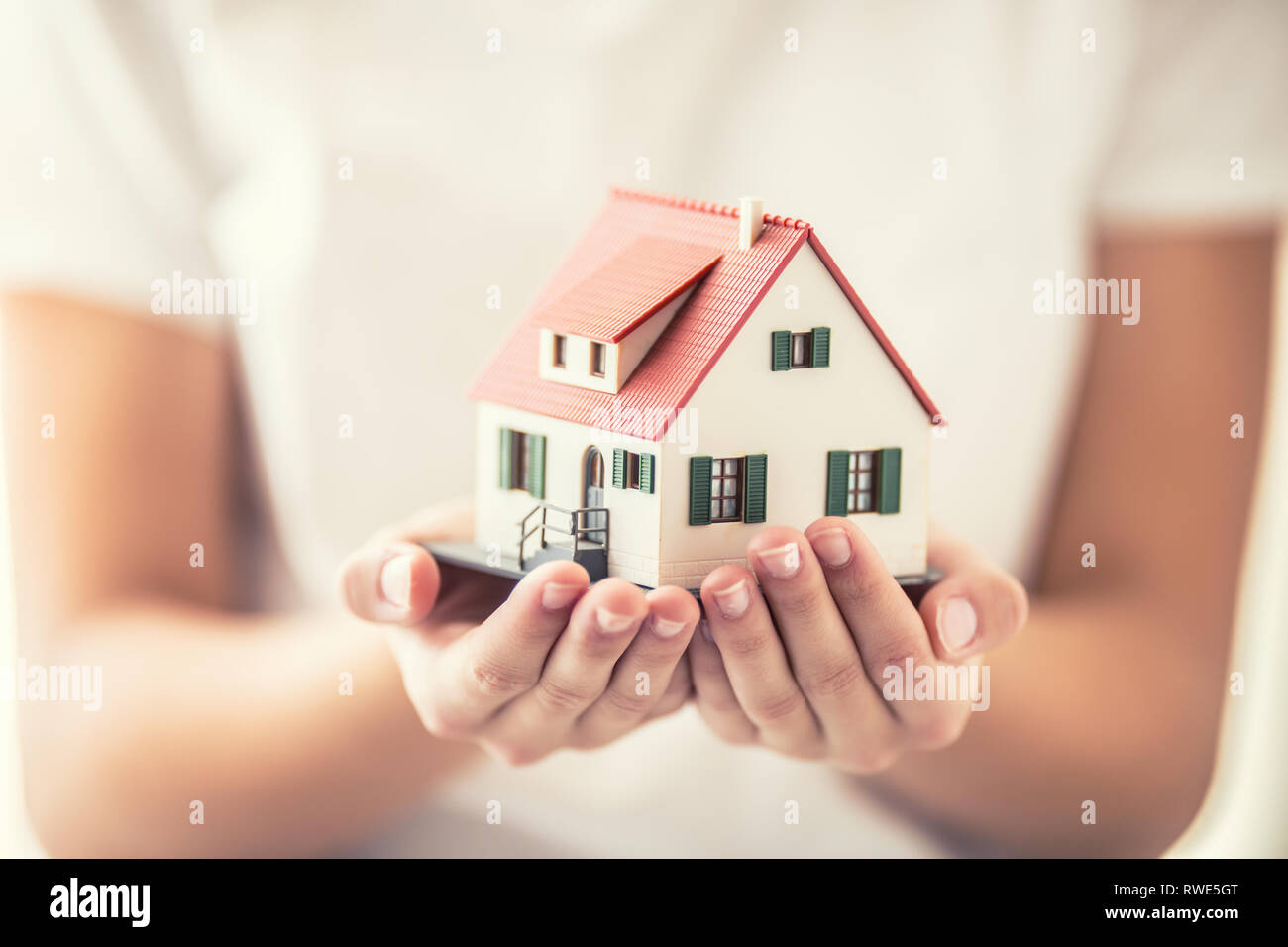 Young woman holding house model hi-res stock photography and images - Alamy
