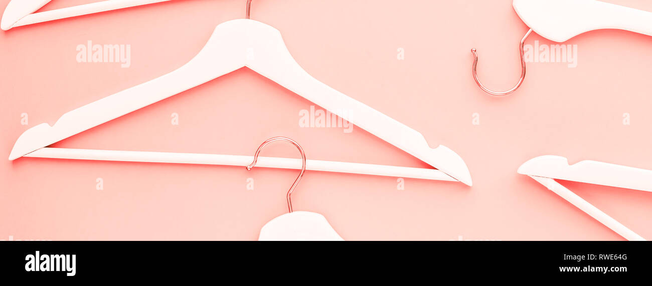 Creative top view flat lay wooden hangers toned living coral color of ...