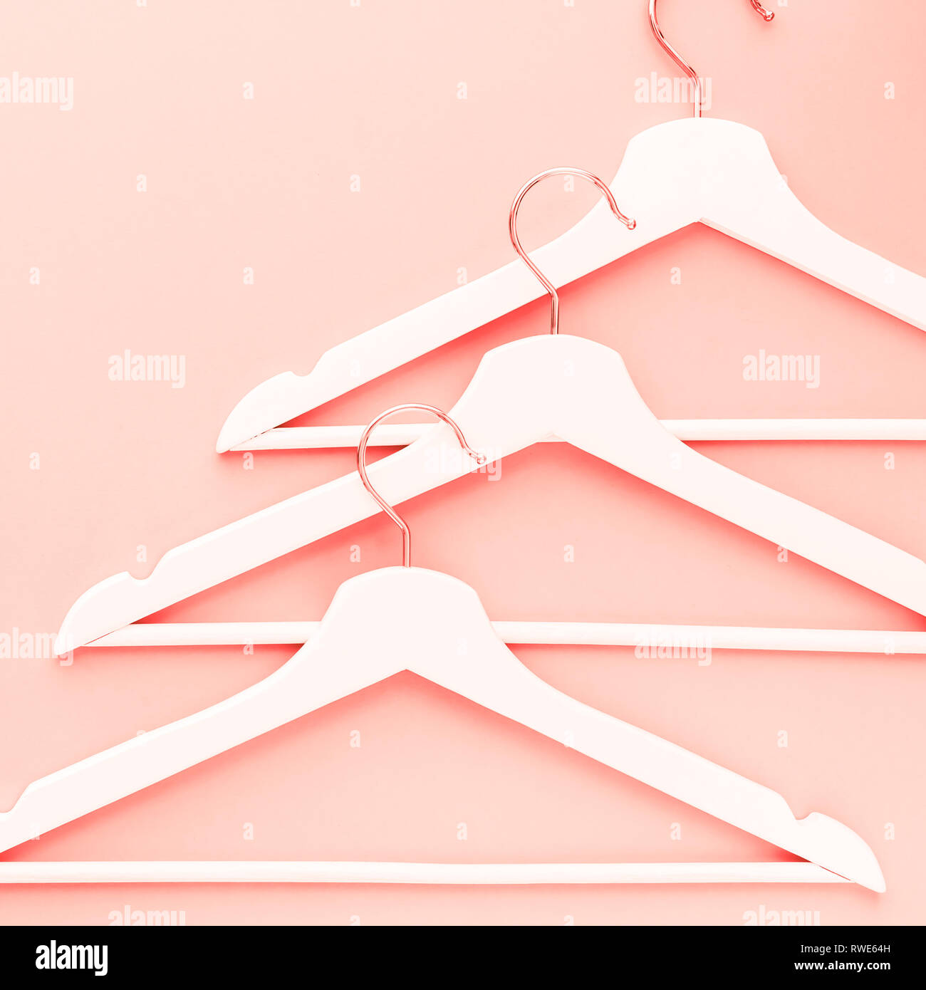 Creative top view flat lay wooden hangers toned living coral color of ...