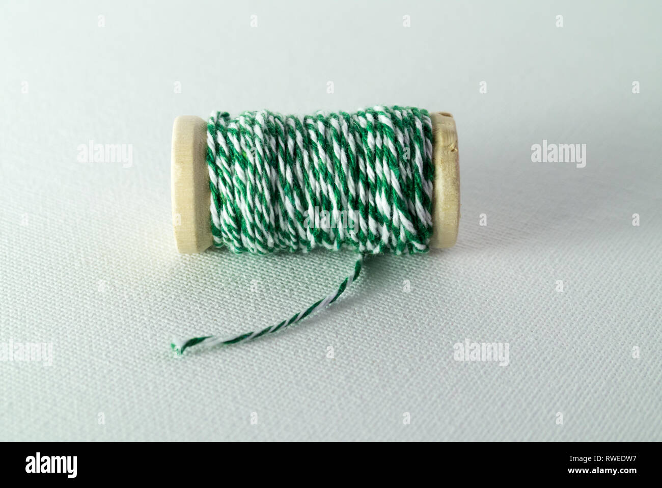 White and Green String on a Wooden Bobbin Stock Photo - Alamy