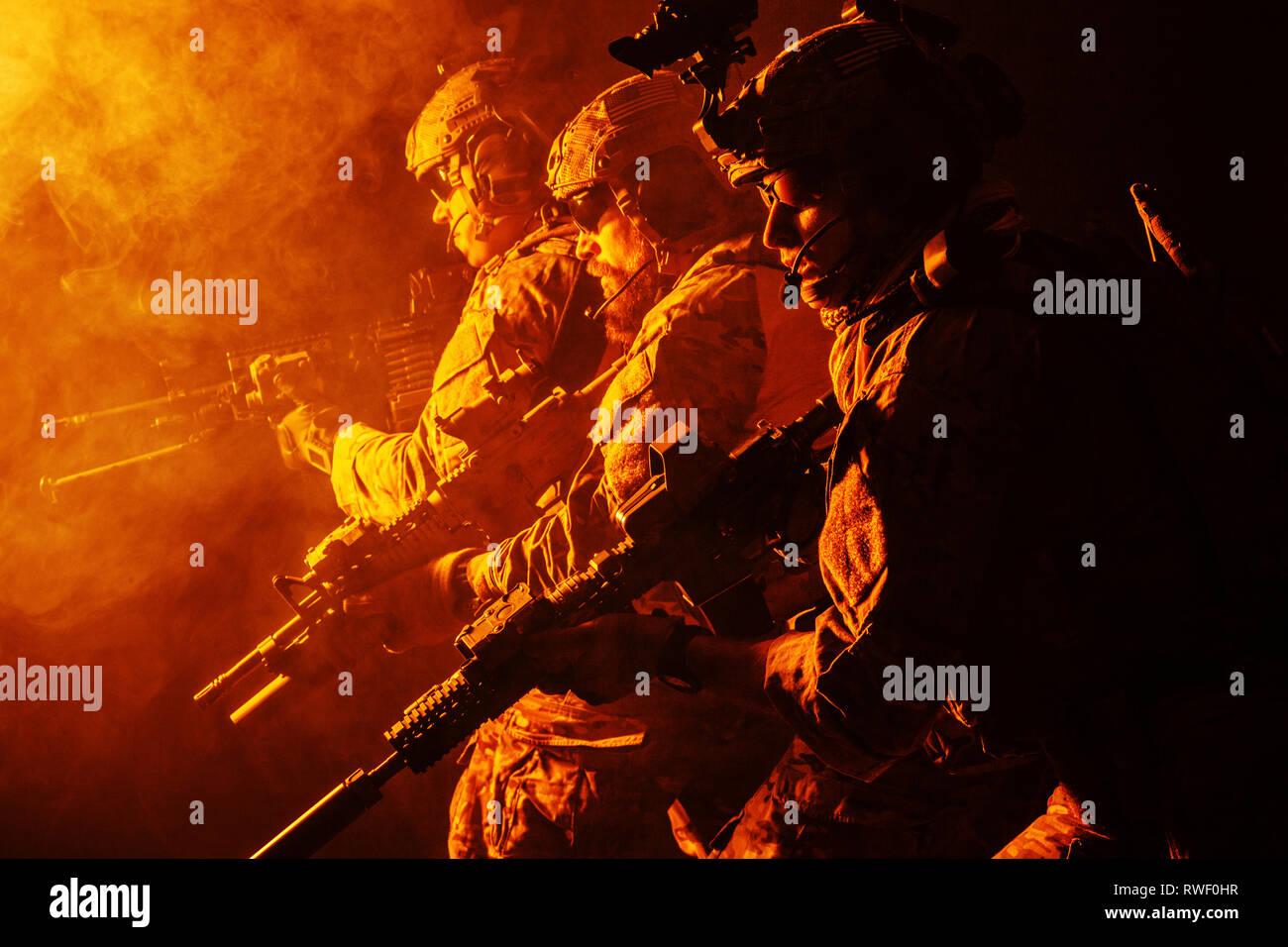 Group of security forces in combat uniforms with rifles, lined in the ...