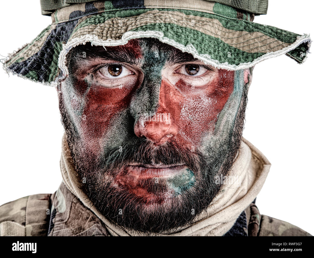 U.S. special forces soldier wearing jungle hat with painted red and ...