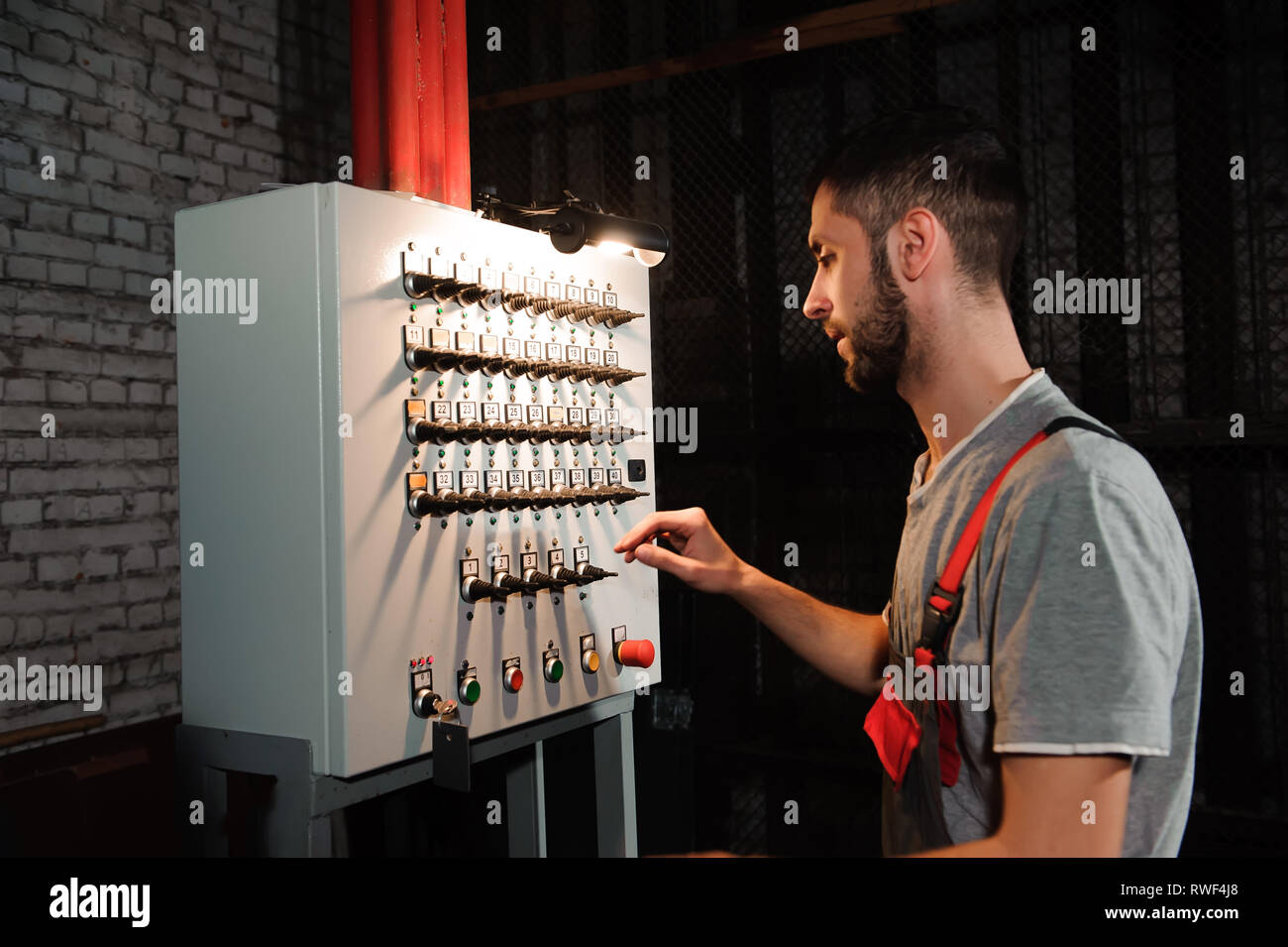 The lighting engineer adjusts the lights on stage behind the scenes ...