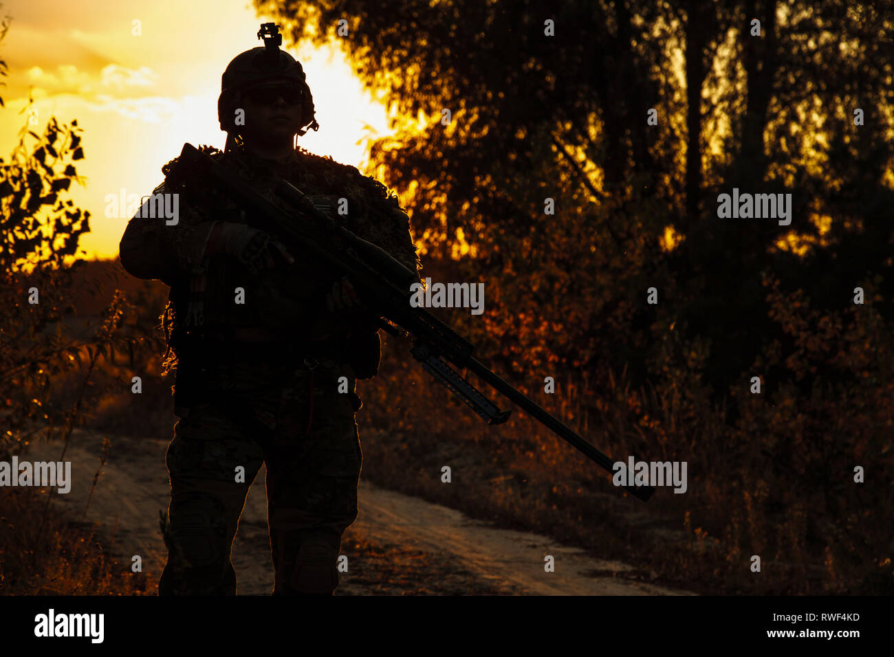 Army sniper with large-caliber rifle in the forest Stock Photo - Alamy