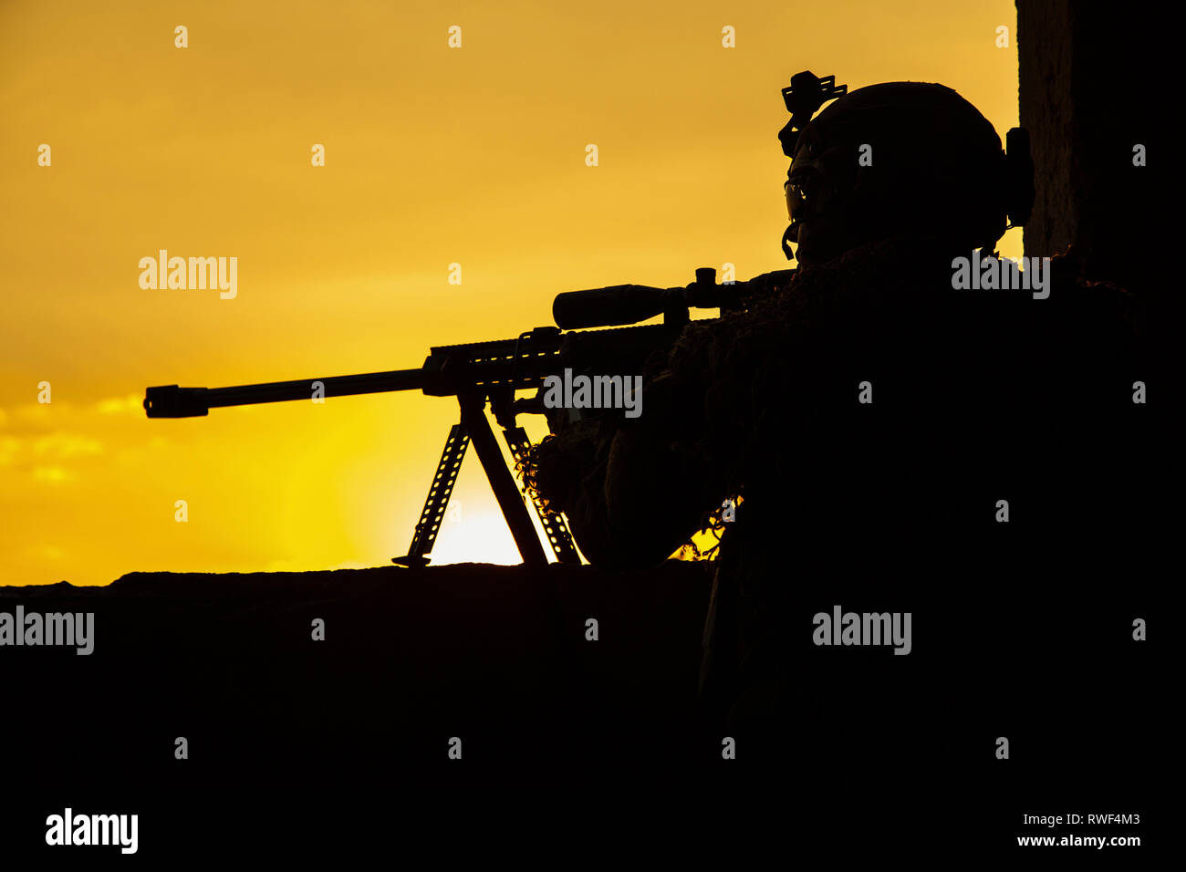 Silhouette of Army sniper with large-caliber rifle against sunset Stock ...