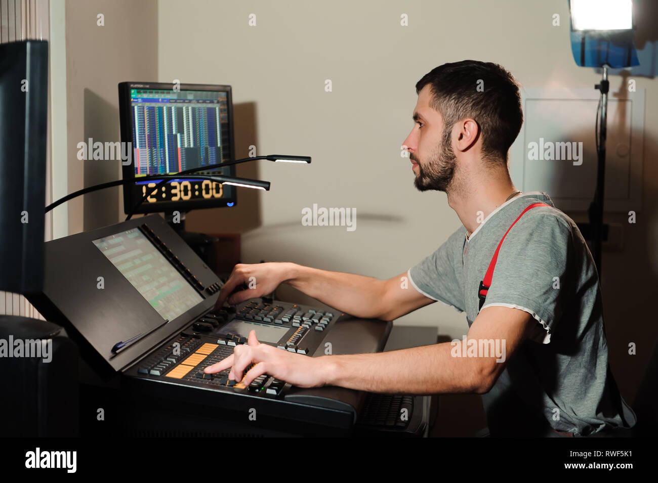 A lighting engineer works with lights technicians control on the ...