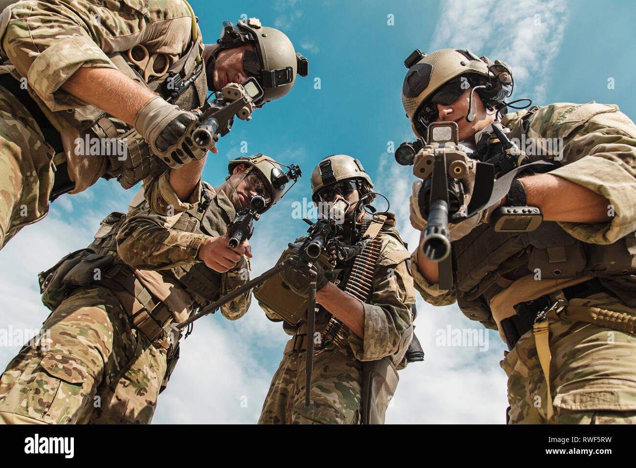 Low angle view of U.S. Army Rangers pointing weapons to the camera ...