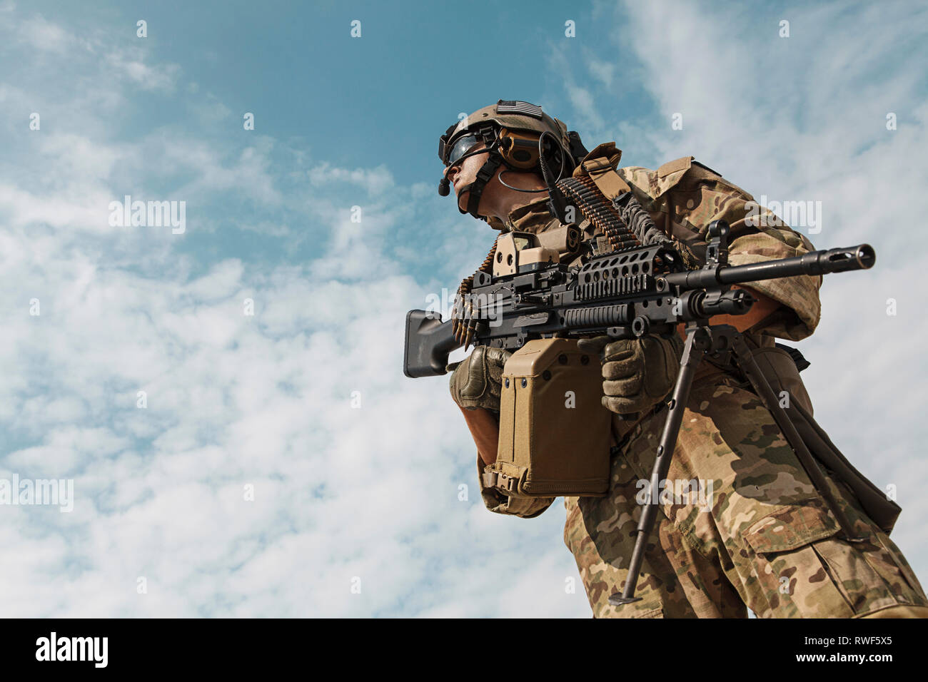 Low angle portrait of U.S. Army Ranger with machine gun, looking up to ...