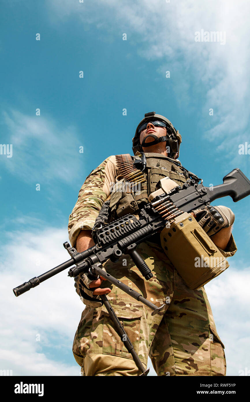 Low angle portrait of U.S. Army Ranger with machine gun, looking up to ...