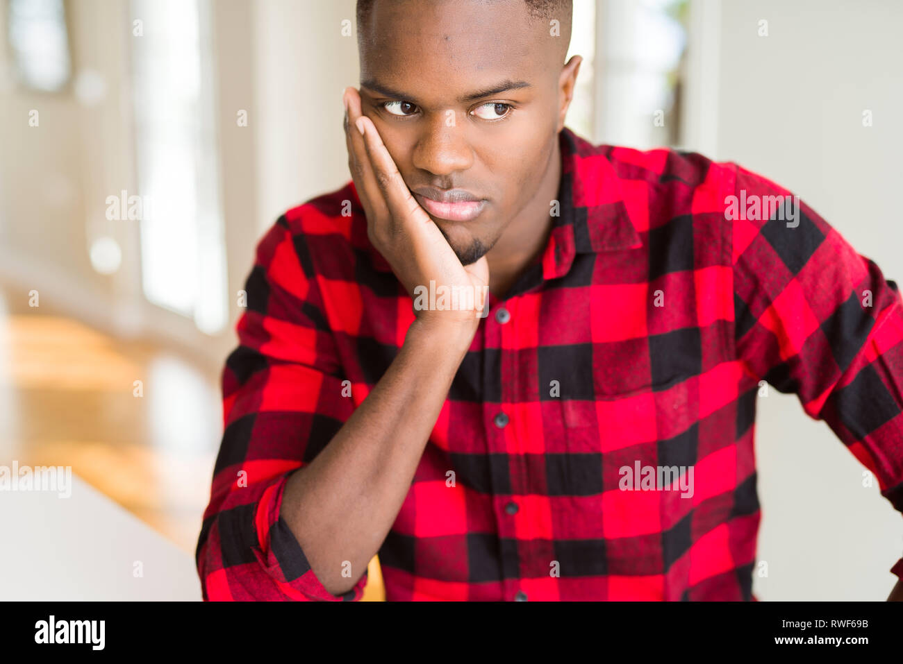 Handsome african american man thinking looking tired and bored with ...