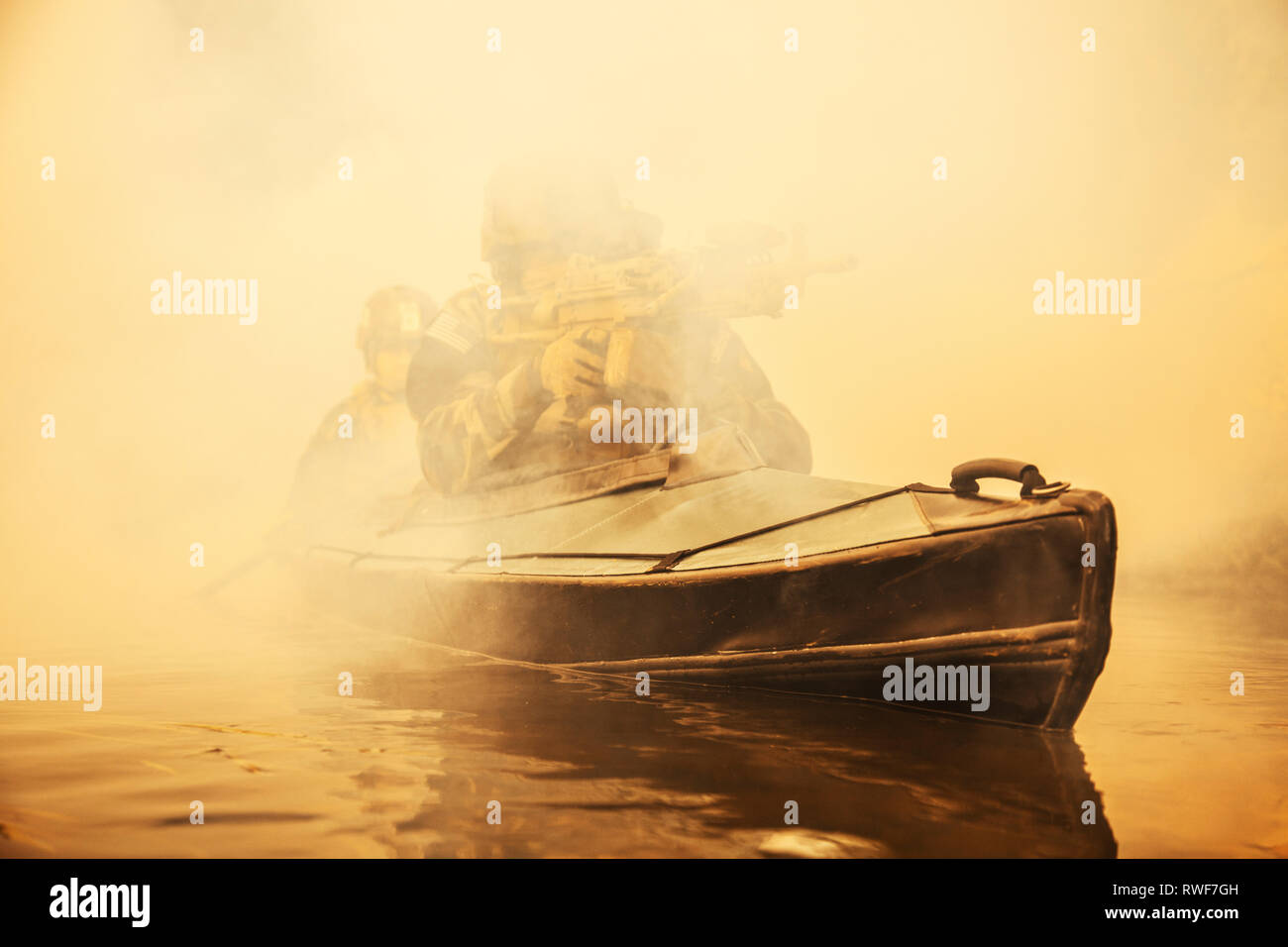 Special forces operator armed with machine gun, paddling Army kayak ...