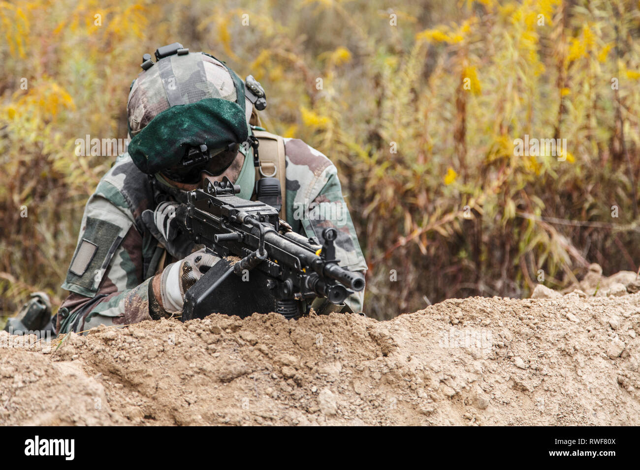 Machine gunner of 1st Marine Infantry Parachute Regiment firing from ...