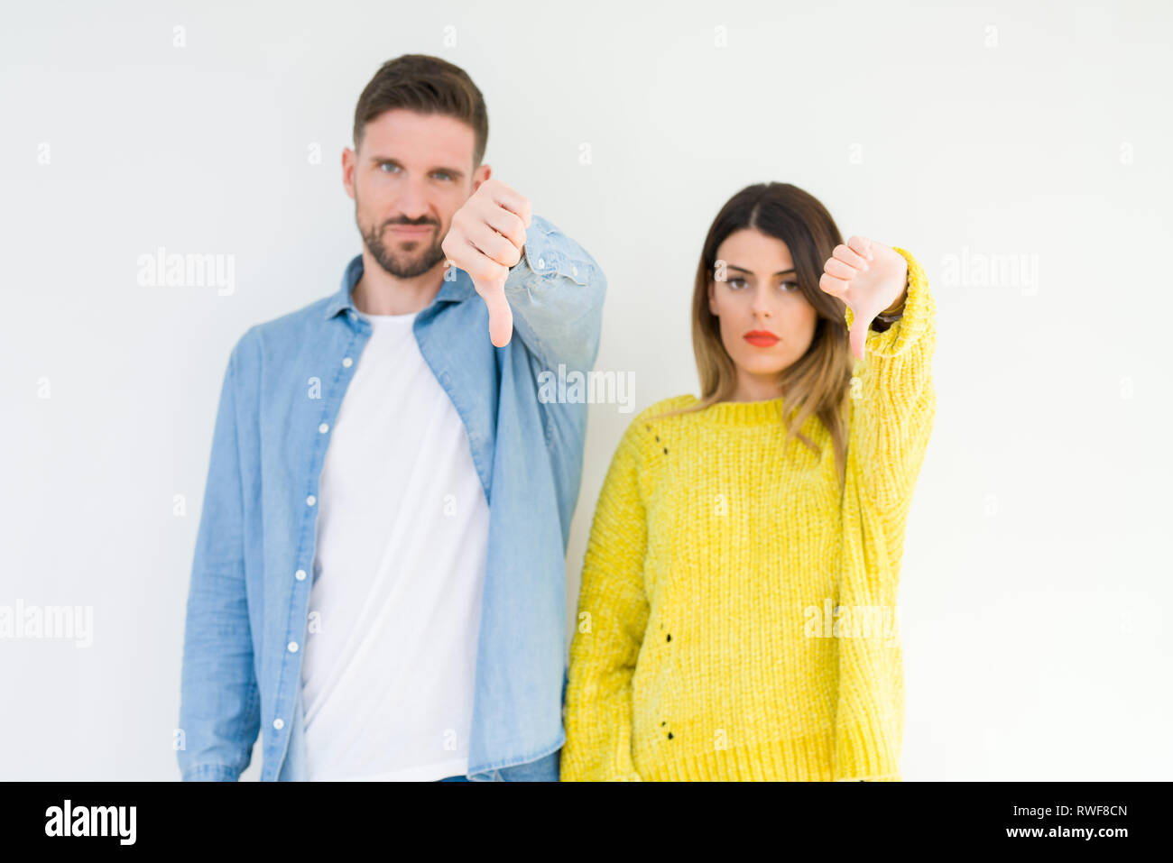 Young beautiful couple togheter over isolated background looking ...