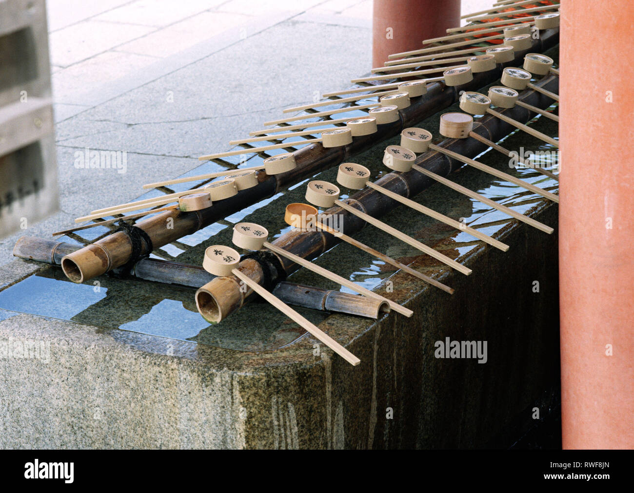 a row of Japanese wooden stick instrument with circular head background ...